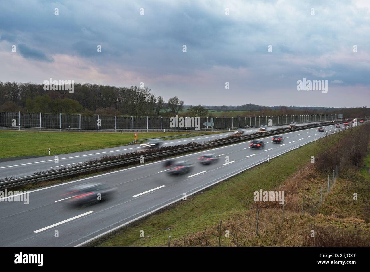 Fast driving cars on a highway under a cloudy sky in Germany, copy ...