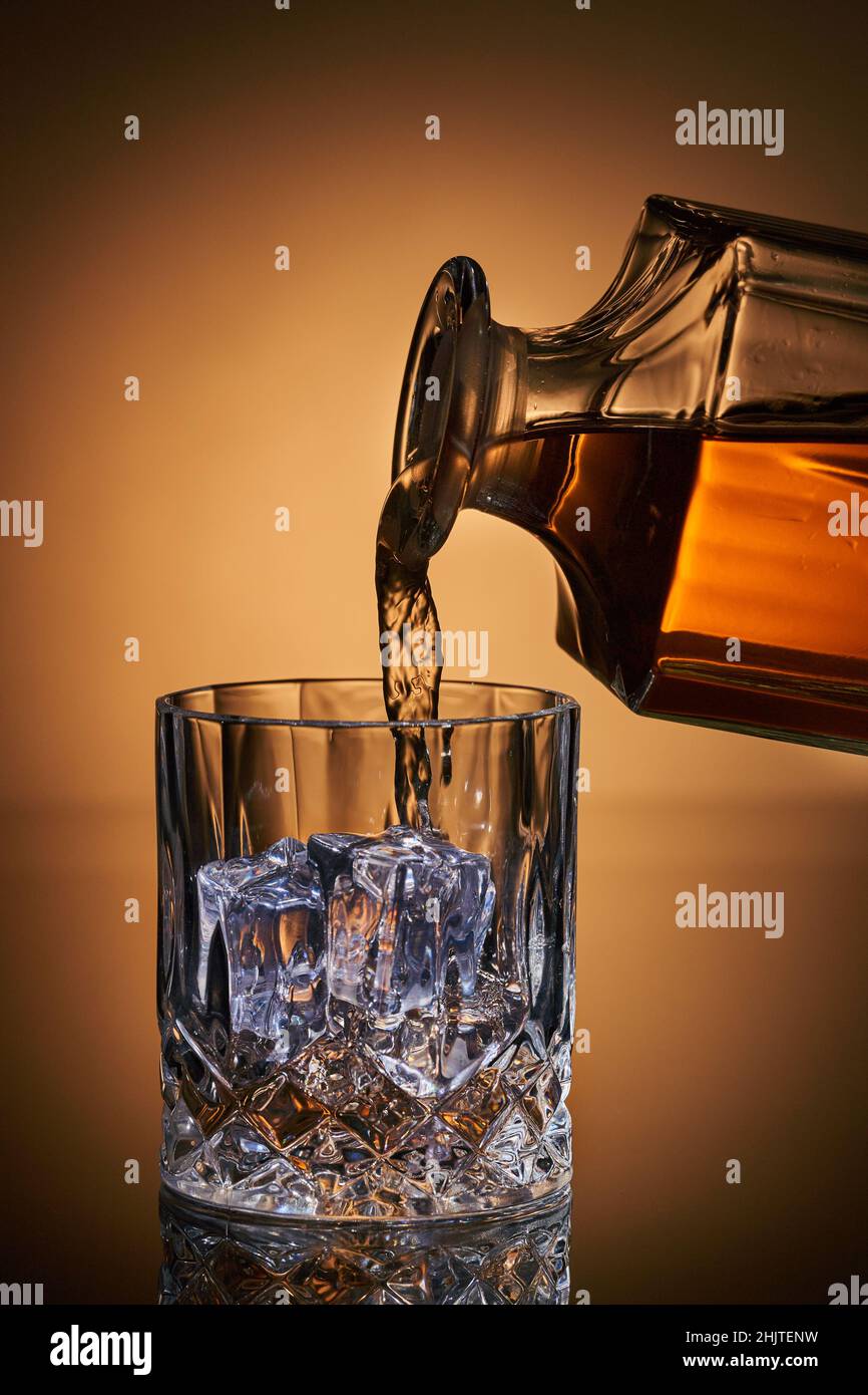 Pouring yellow liquid over ice hi-res stock photography and images - Alamy
