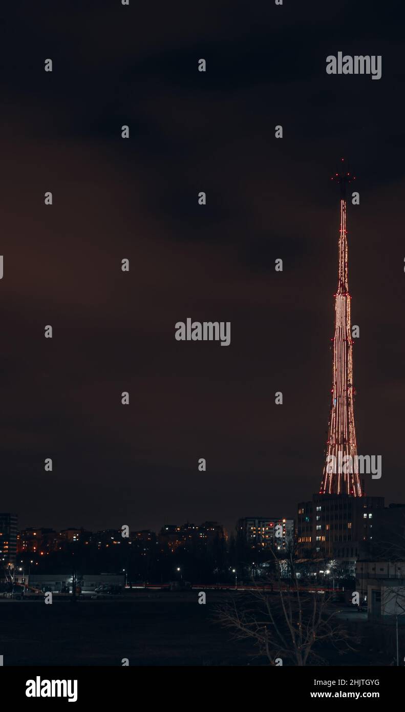 Night view of a city with buildings and a tower Stock Photo - Alamy