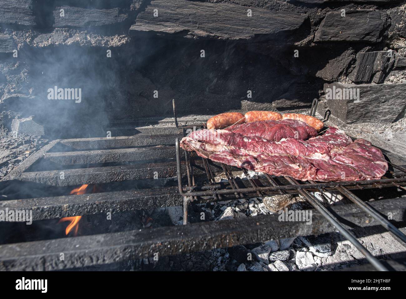 Typical Uruguayan and Argentine Asado Cooked on fire. Entrana and Vacio ...
