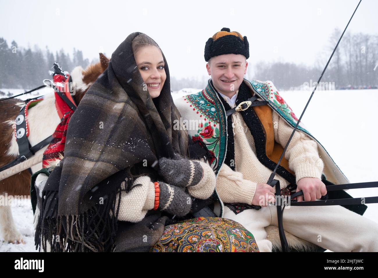 Highlanders dressed in traditional clothes seen in a sleigh with horses ...