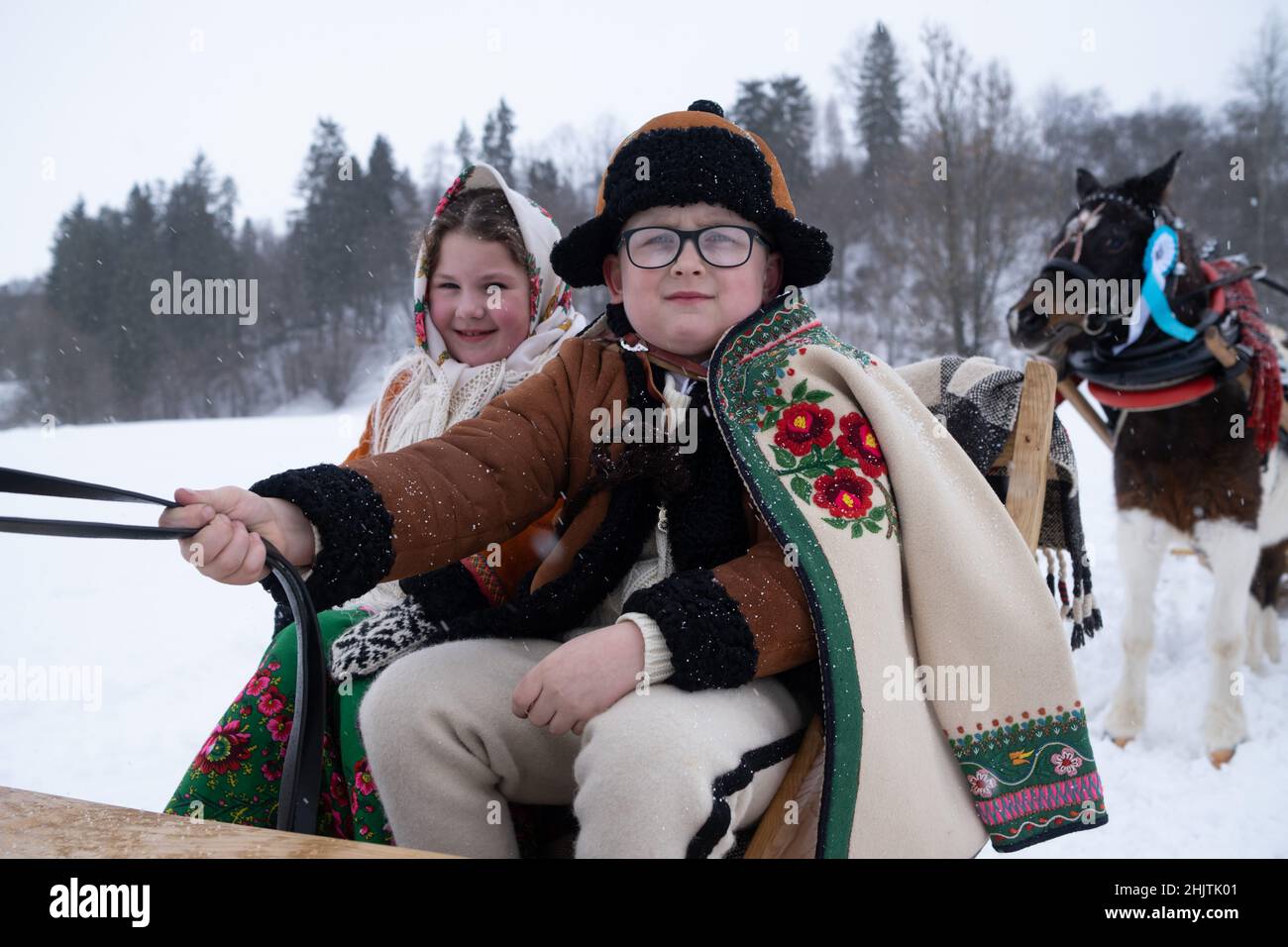 Highlanders dressed in traditional clothes seen in a sleigh with horses ...