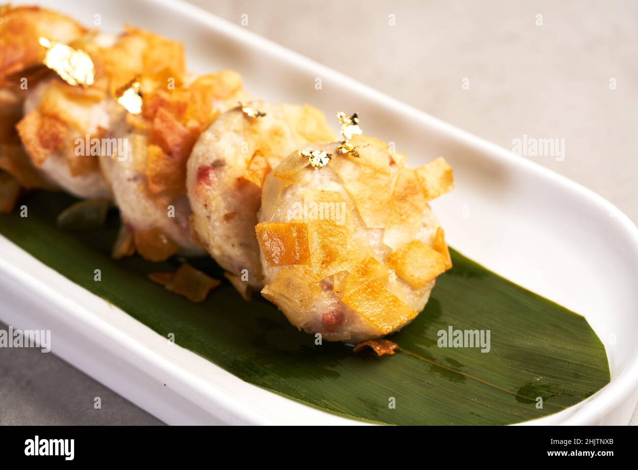 Closeup shot of fried pieces of meat served on the green leaf with ...