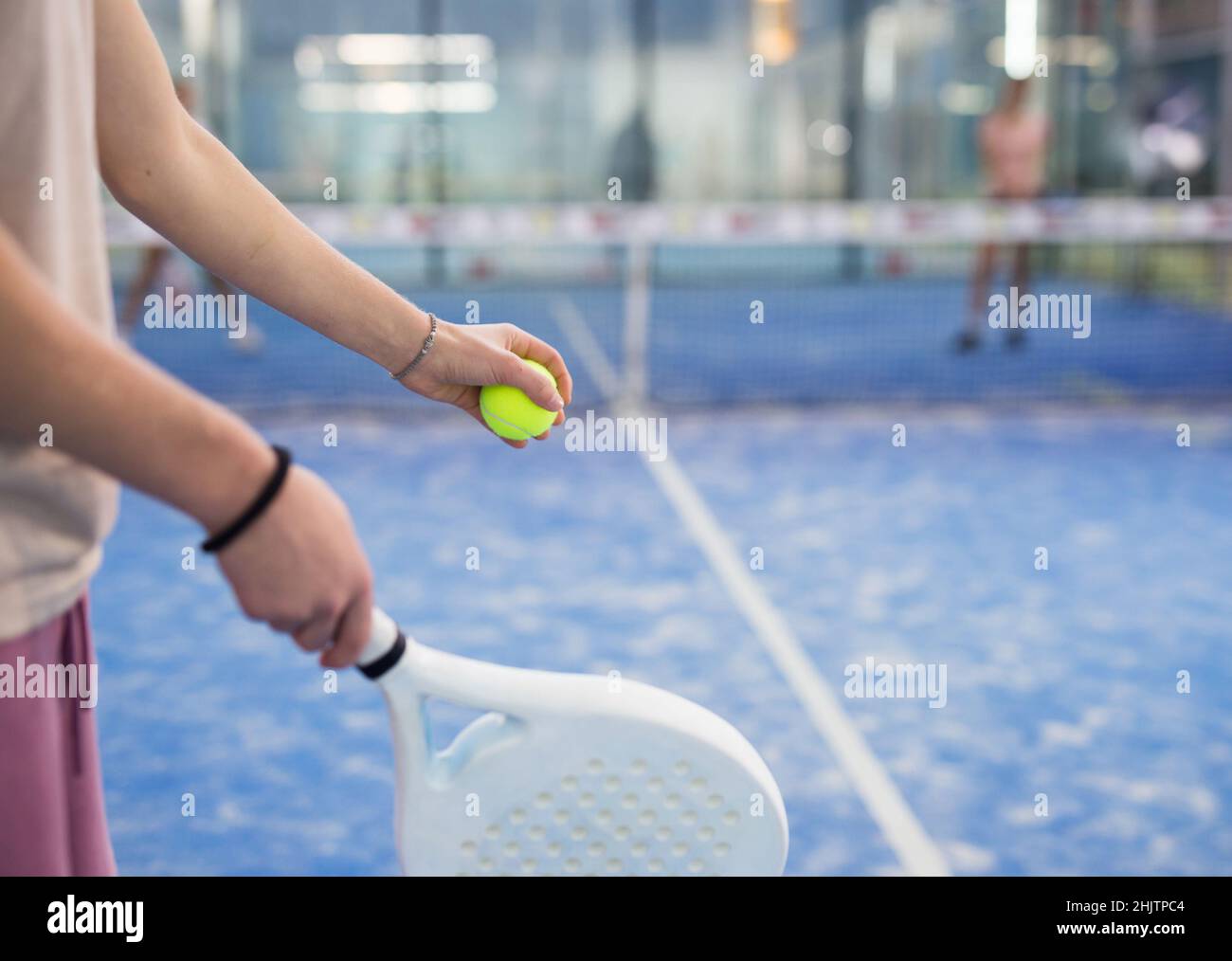 Hands of padel player holding racquet and ball Stock Photo - Alamy