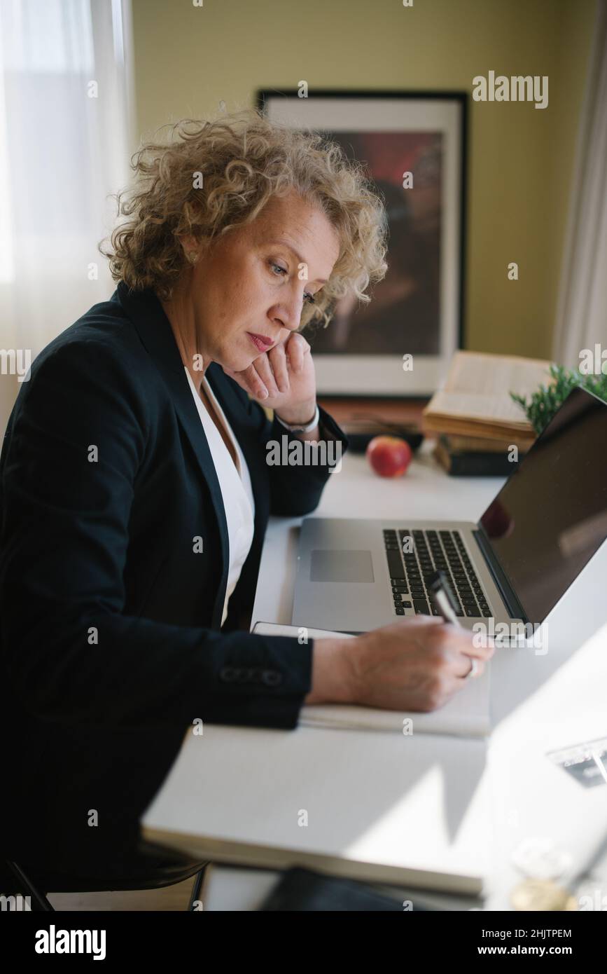 Middle-aged woman working at home Stock Photo - Alamy