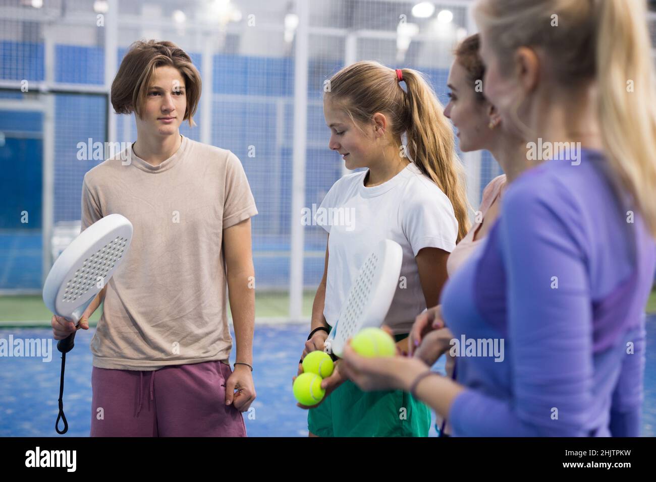 Four padel players standing in court and resting Stock Photo - Alamy