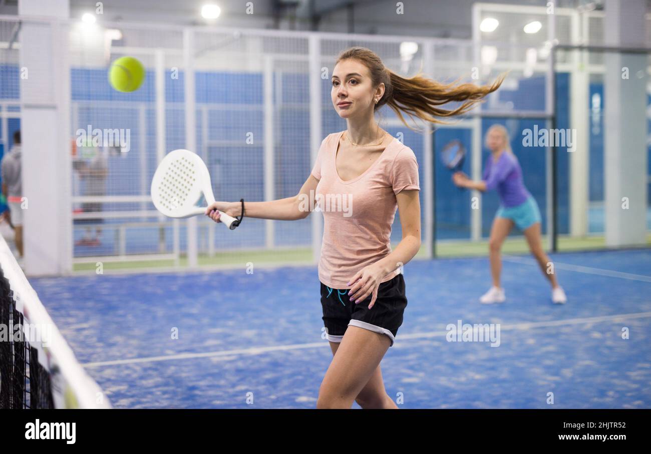 Active sports girl playing padel on tennis court Stock Photo - Alamy