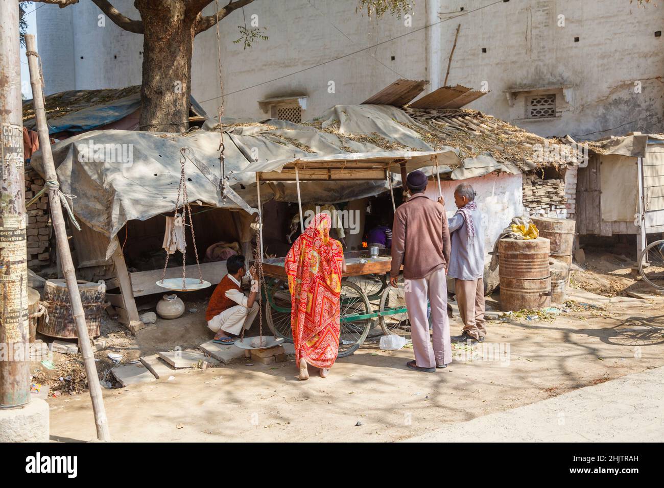 A roadside stall and barrow being set up by local people in suburban ...