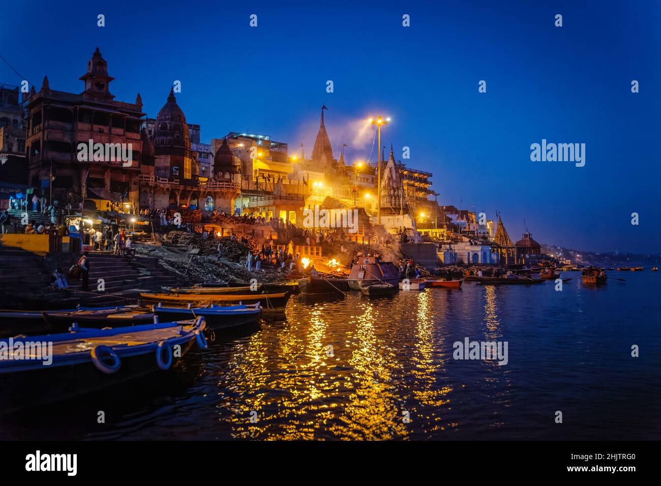 Funeral pyres burning at night on Manikarnika Ghat at Varanasi ...