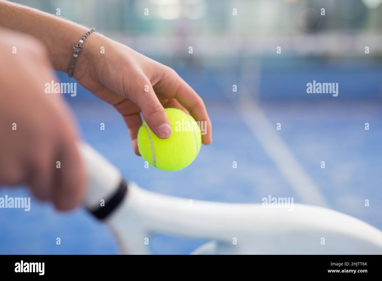 Hands of padel player holding racquet and ball Stock Photo - Alamy