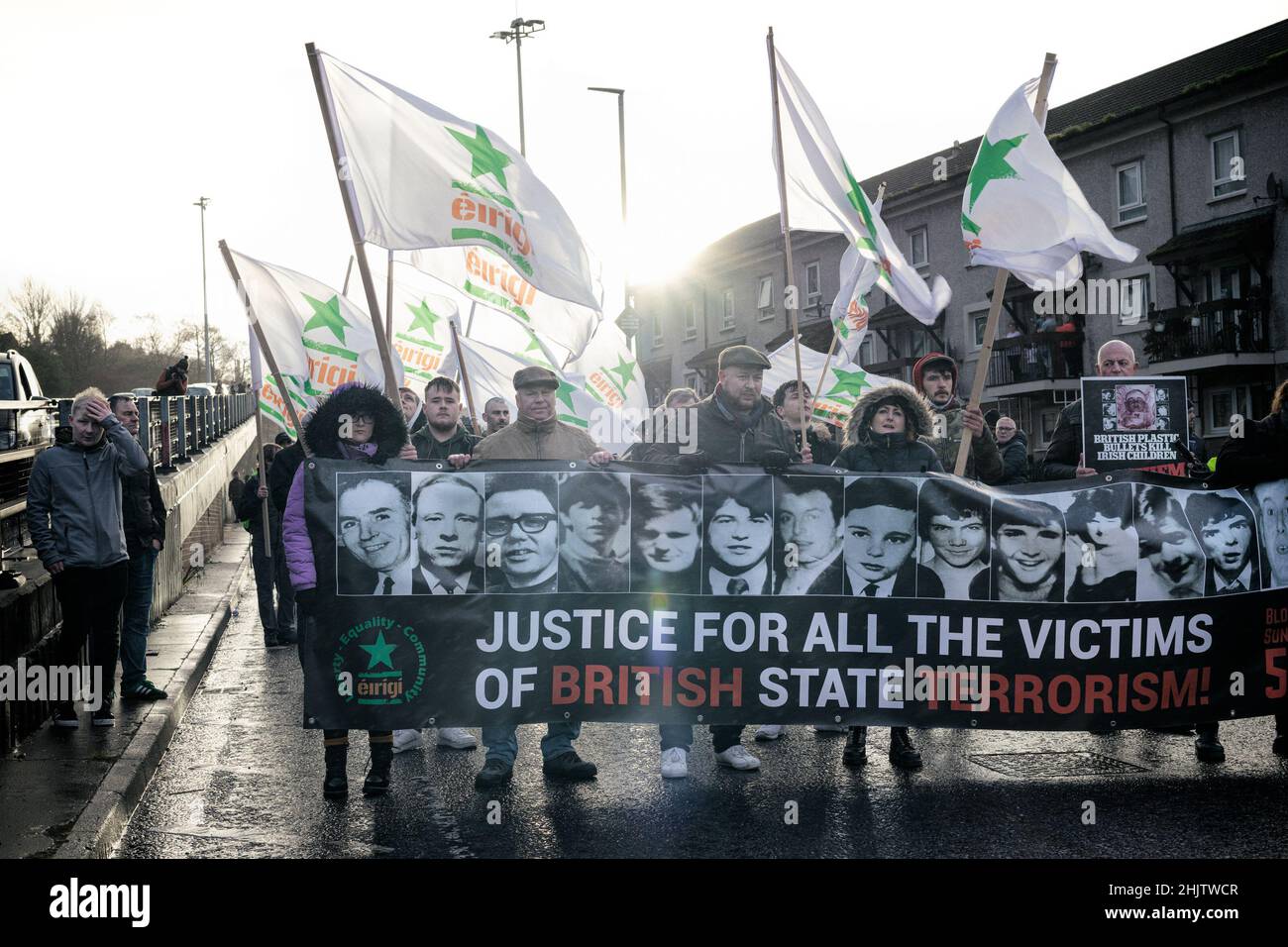 Demonstrators hold banners and flag as they march in remembrance for ...