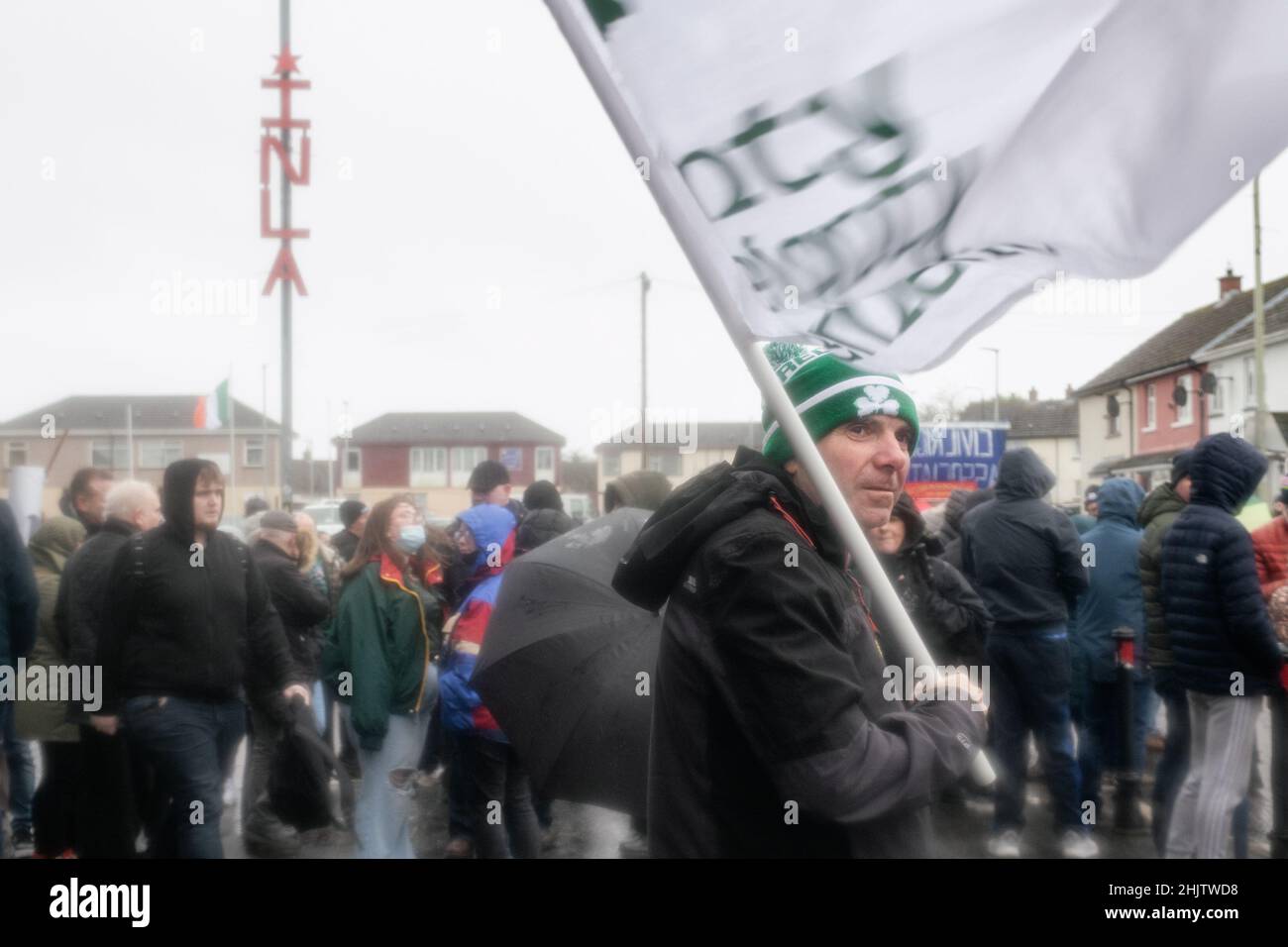 Derry, UK. 30th Jan, 2022. Flag bearers prepare to march through the ...
