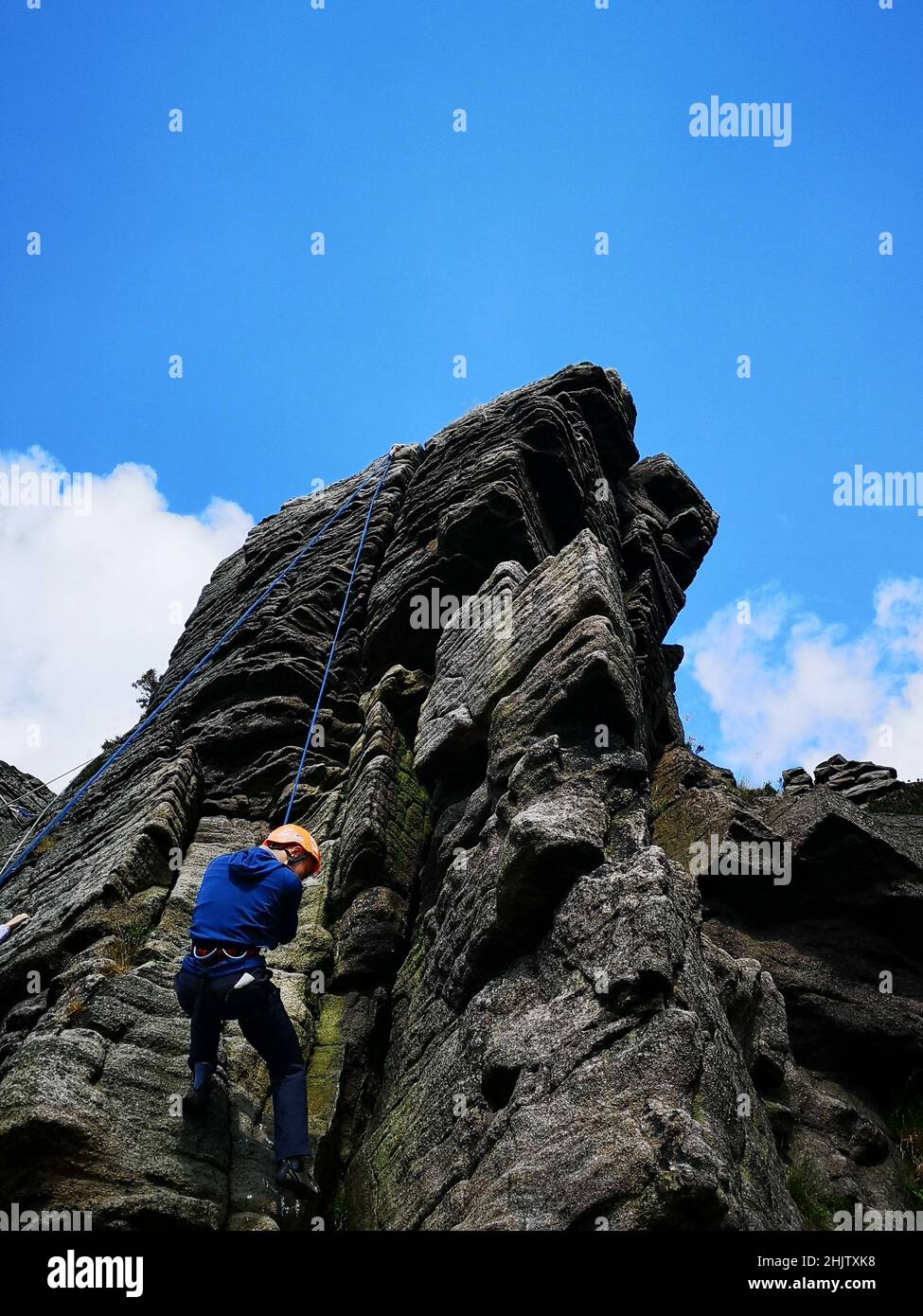 Low angle shot of a man climbing on a hill Stock Photo - Alamy