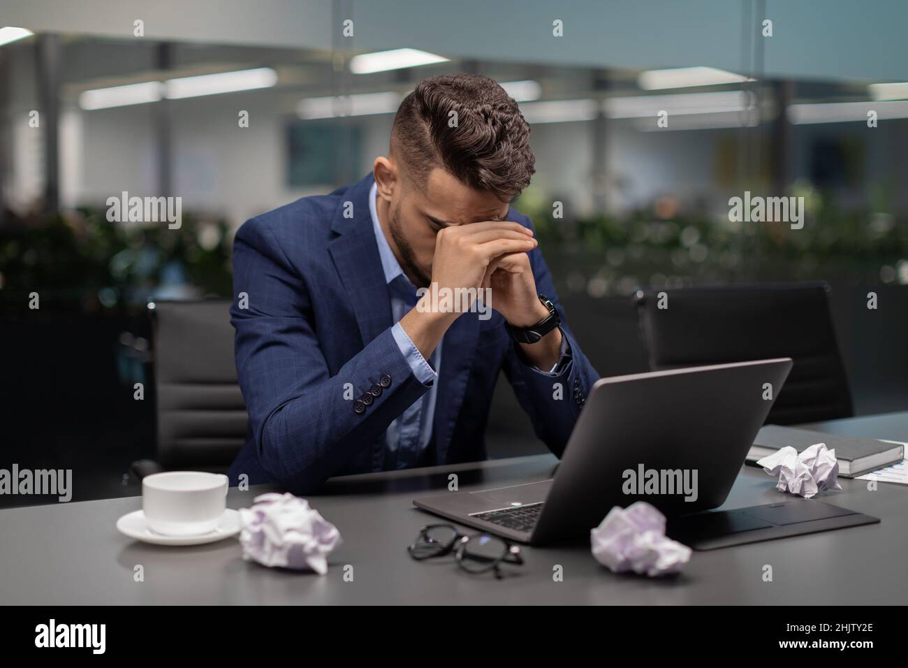 Tired arab man financial manager sitting in front of computer Stock ...