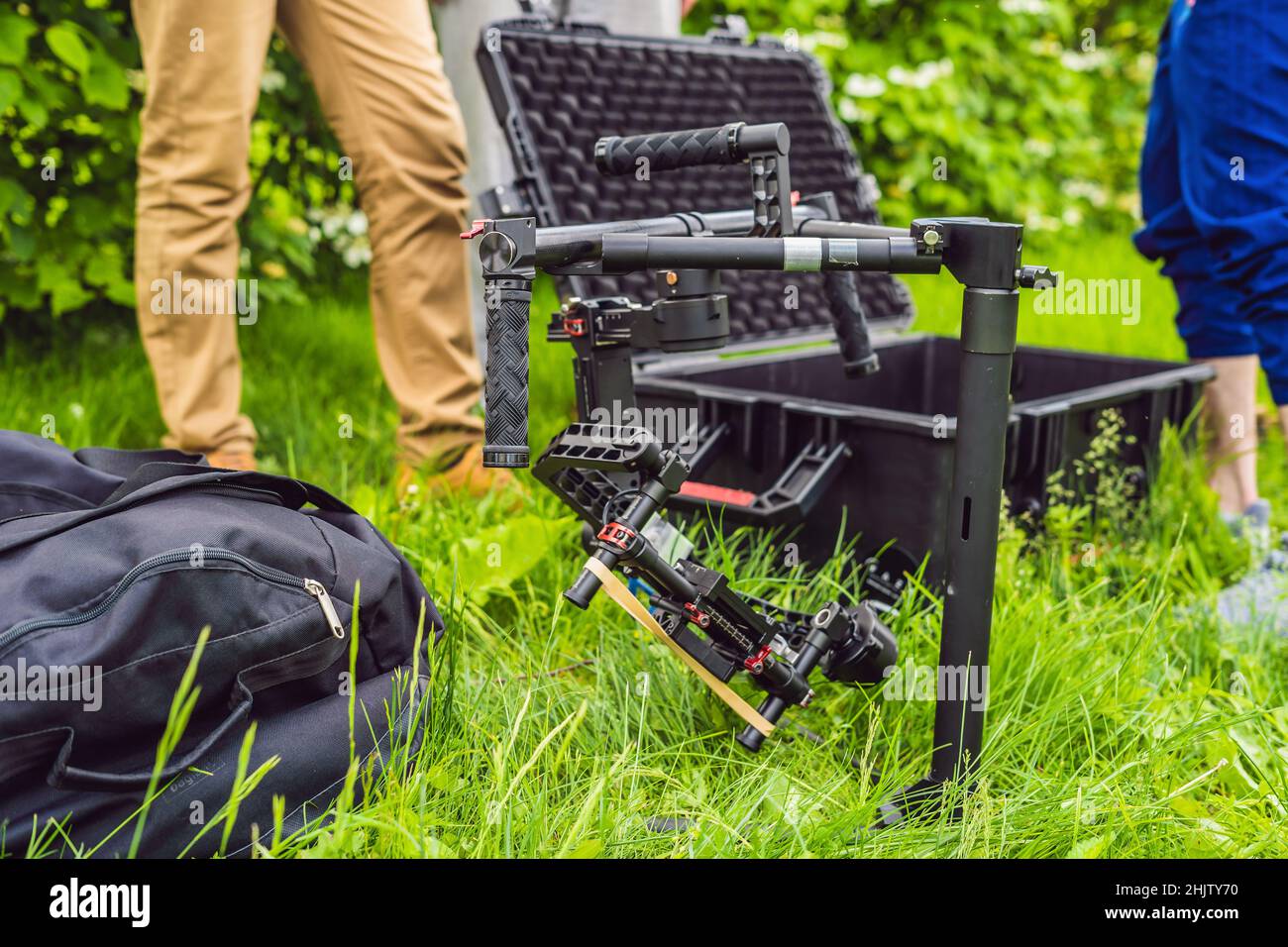 Cameraman setting up heavy duty professional 3-axis gimbal stabilizer ...