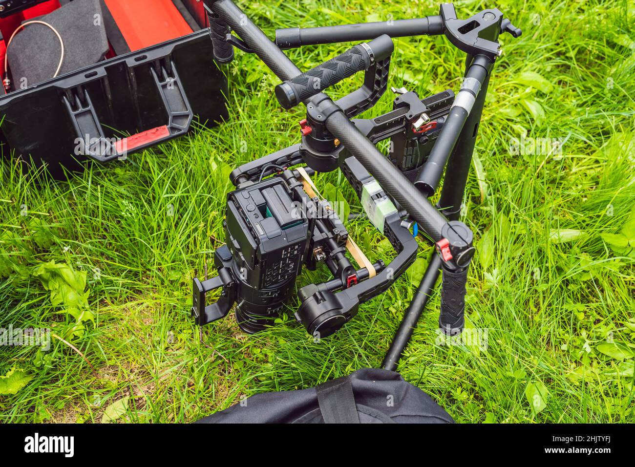 Cameraman setting up heavy duty professional 3-axis gimbal stabilizer ...