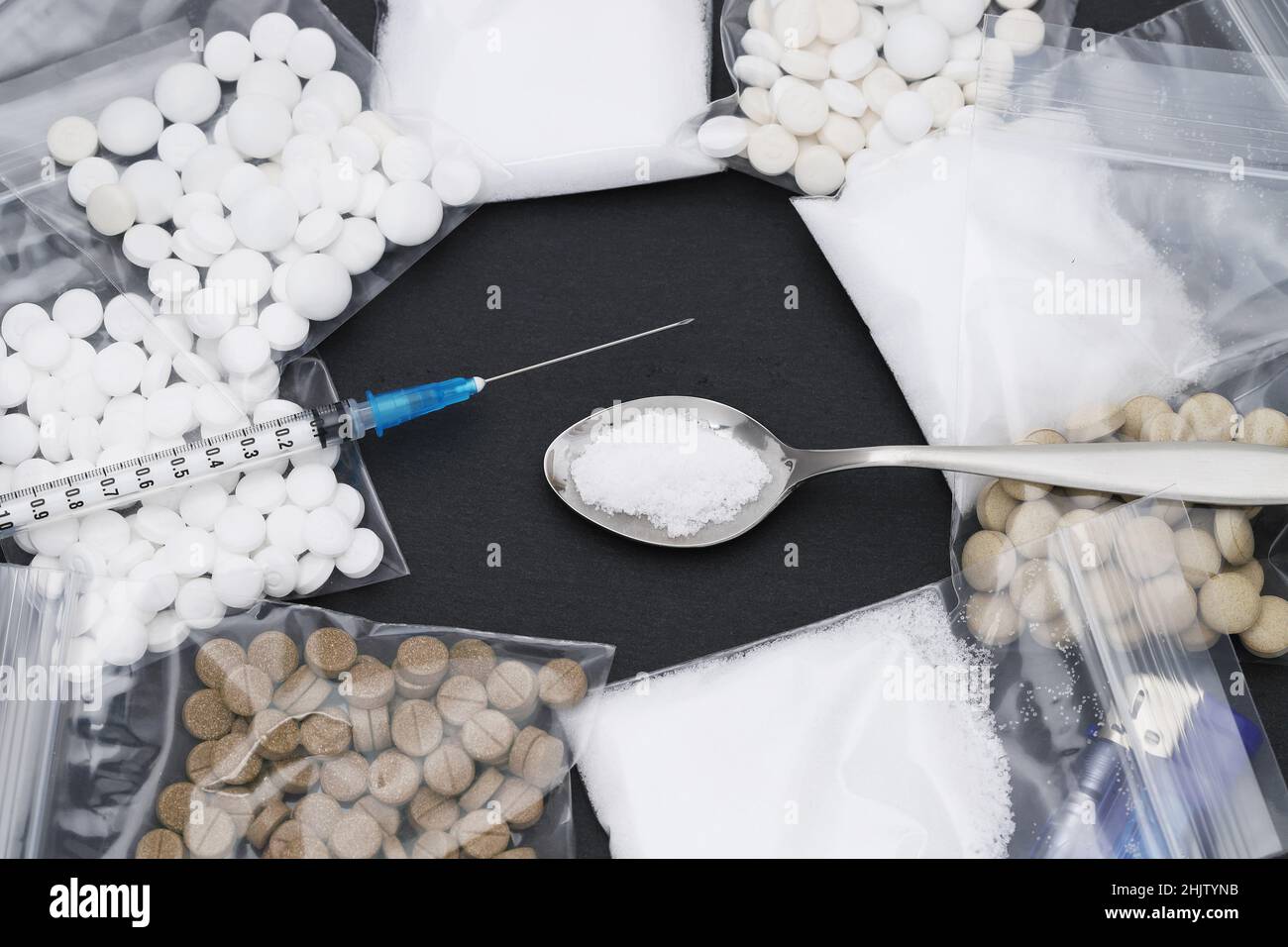 Cooked heroin drugs and injection syringe on black background Stock Photo - Alamy