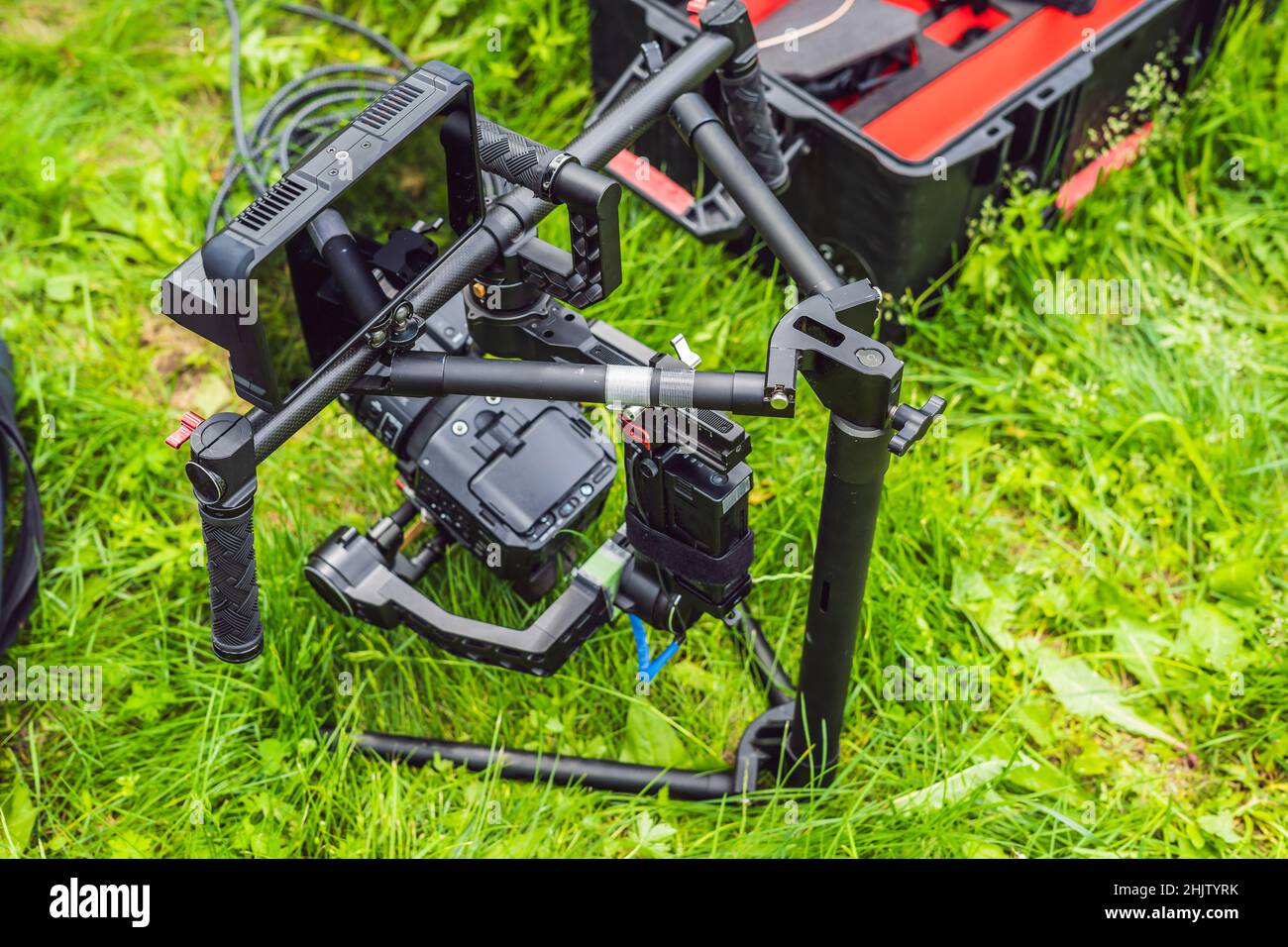 Cameraman setting up heavy duty professional 3-axis gimbal stabilizer ...