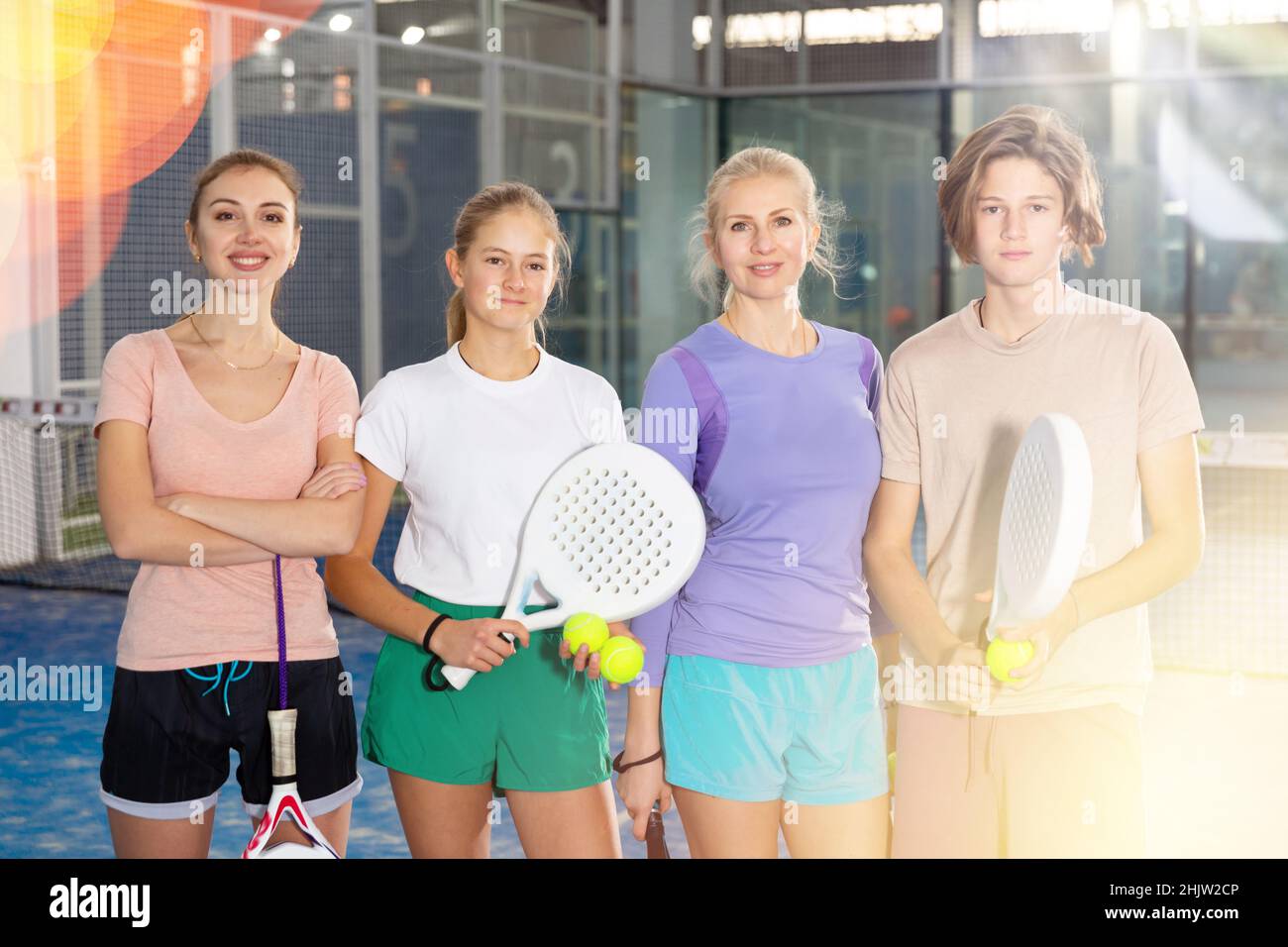 Group photo of four padel players standing in court Stock Photo - Alamy