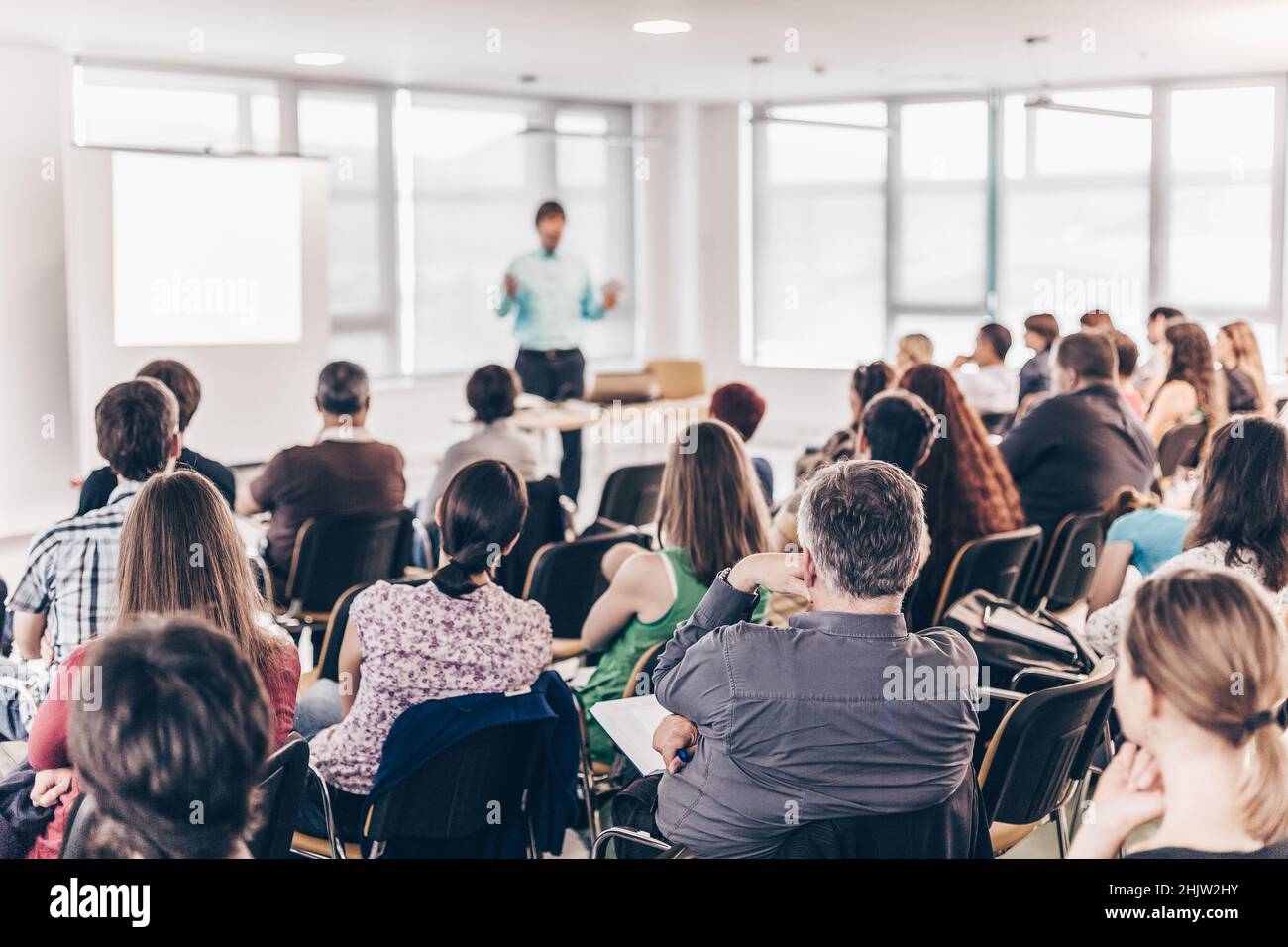 Speaker giving presentation on business conference lecture Stock Photo ...
