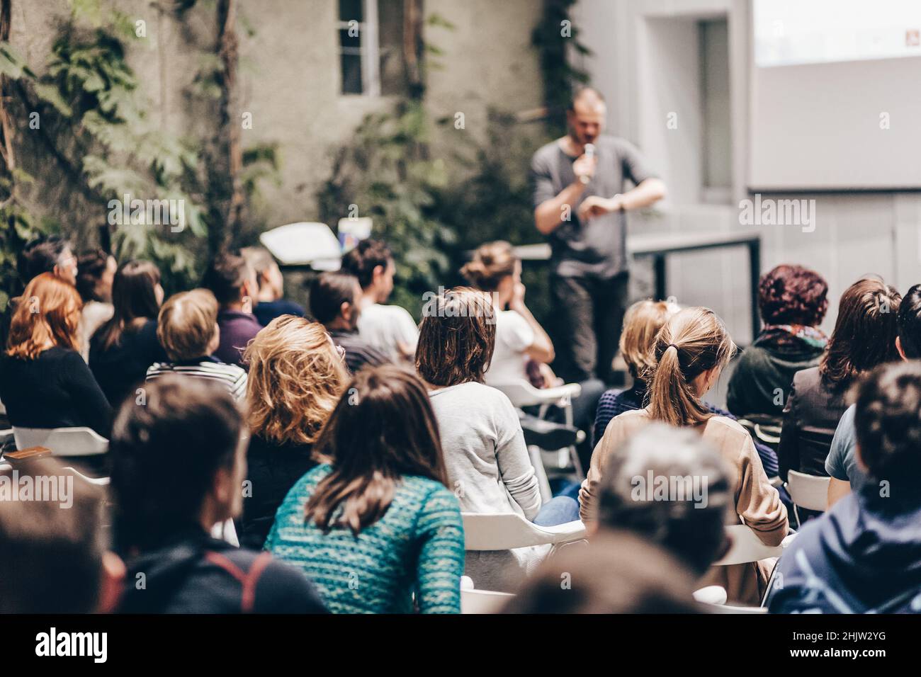 Man giving presentation in lecture hall at university Stock Photo - Alamy