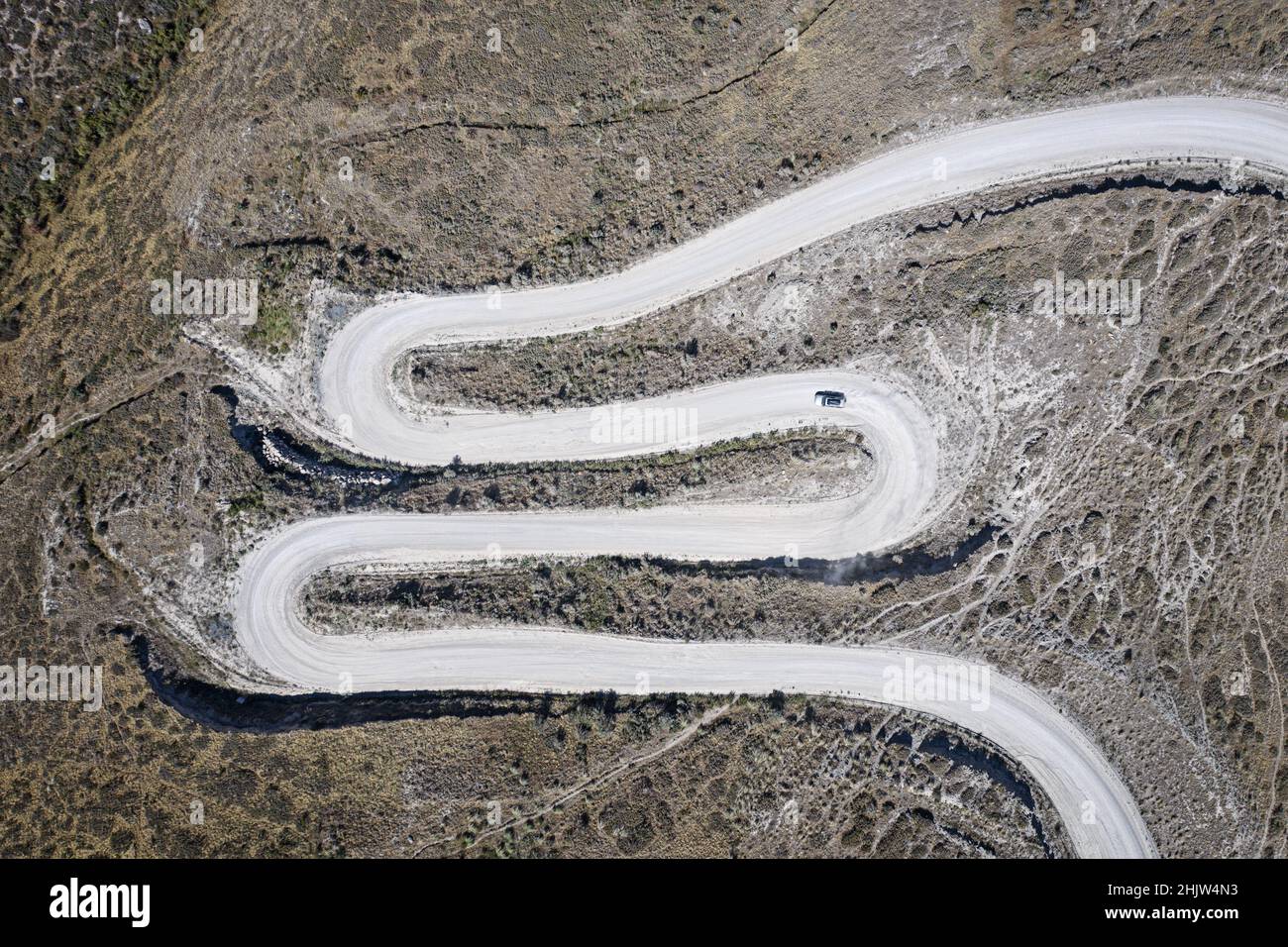 Aerial view of a car driving the serpentine gravel highway road Stock ...