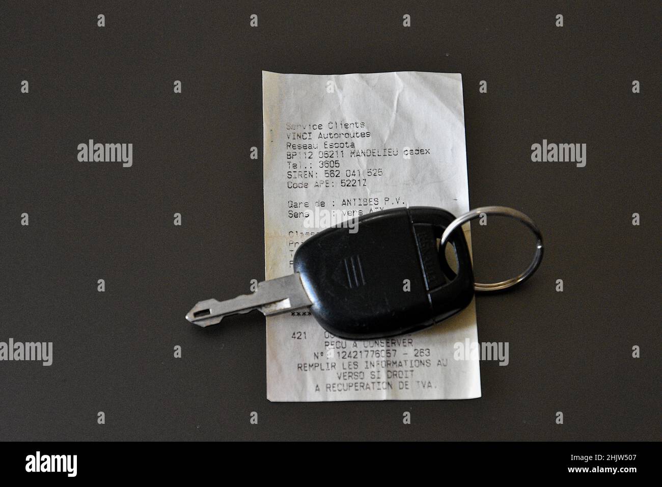 In this photo illustration, a highway toll ticket and a car key are ...