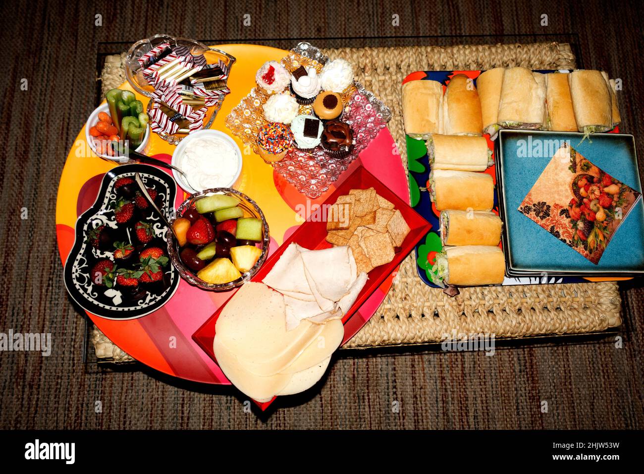 Snacks laid out for guests of sandwiches sweets cheese and fruit. St ...