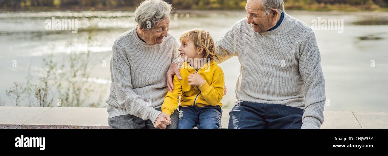 Senior couple with baby grandson in the autumn park. Great-grandmother ...