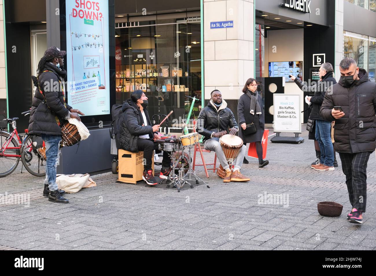 Group of people playing instruments on the street in the center of ...