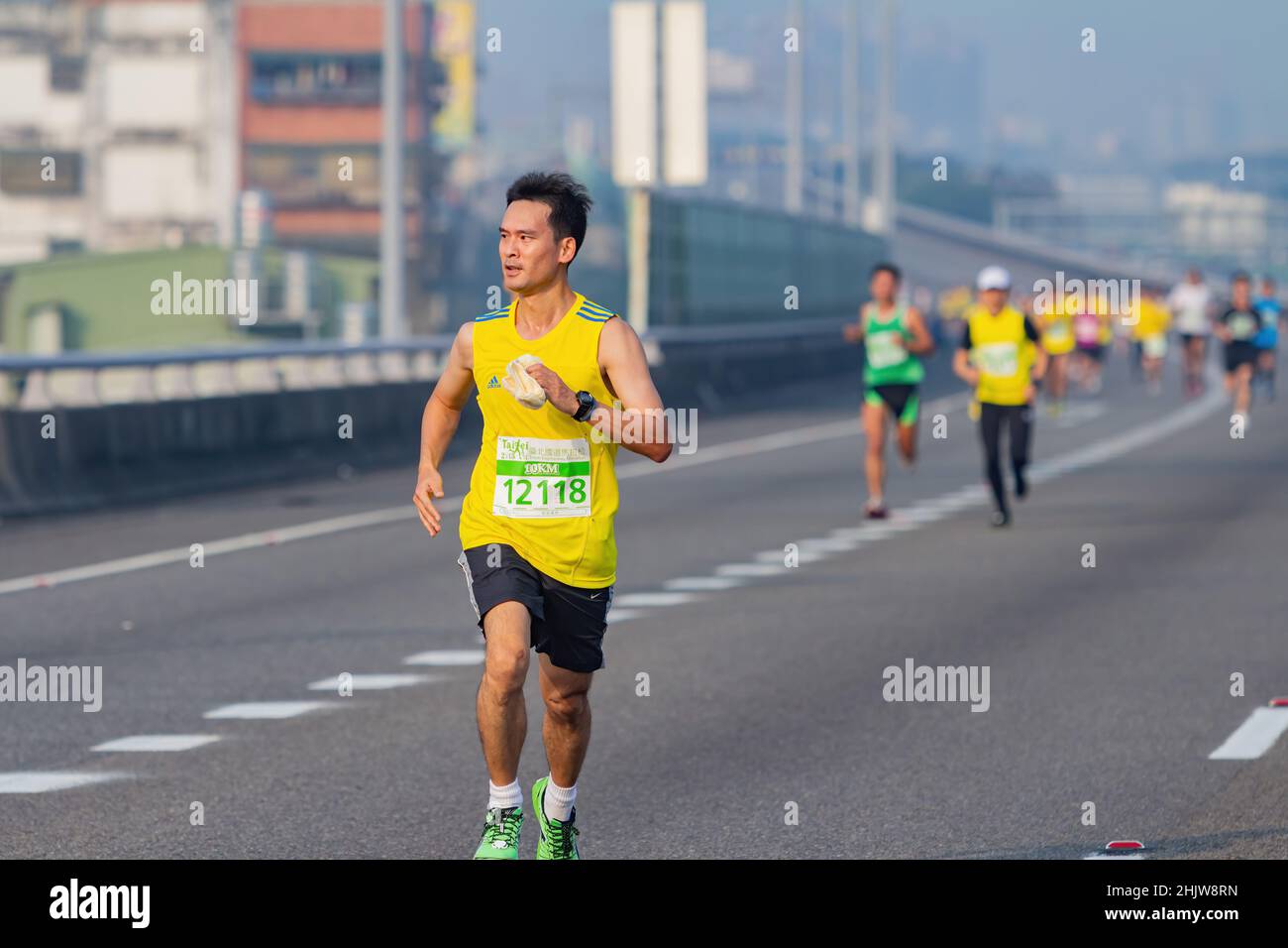 Taipei, MAR 17 2013 - Close up shot of people running in highway ...