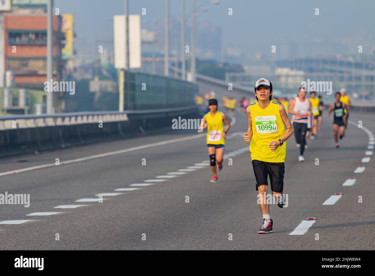 Taipei, MAR 17 2013 - Close up shot of people running in highway ...