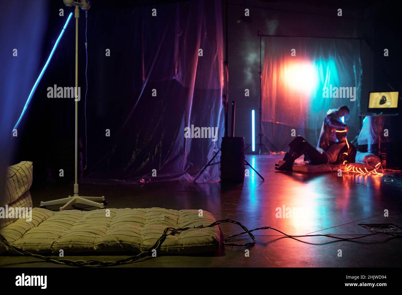 Part of hacker hideouts illuminated by neon lights with matress ...