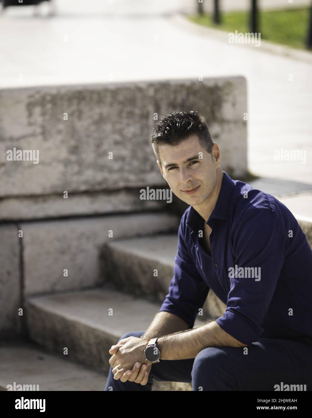 Architect wearing a formal outfit sitting alone on the concrete stairs ...