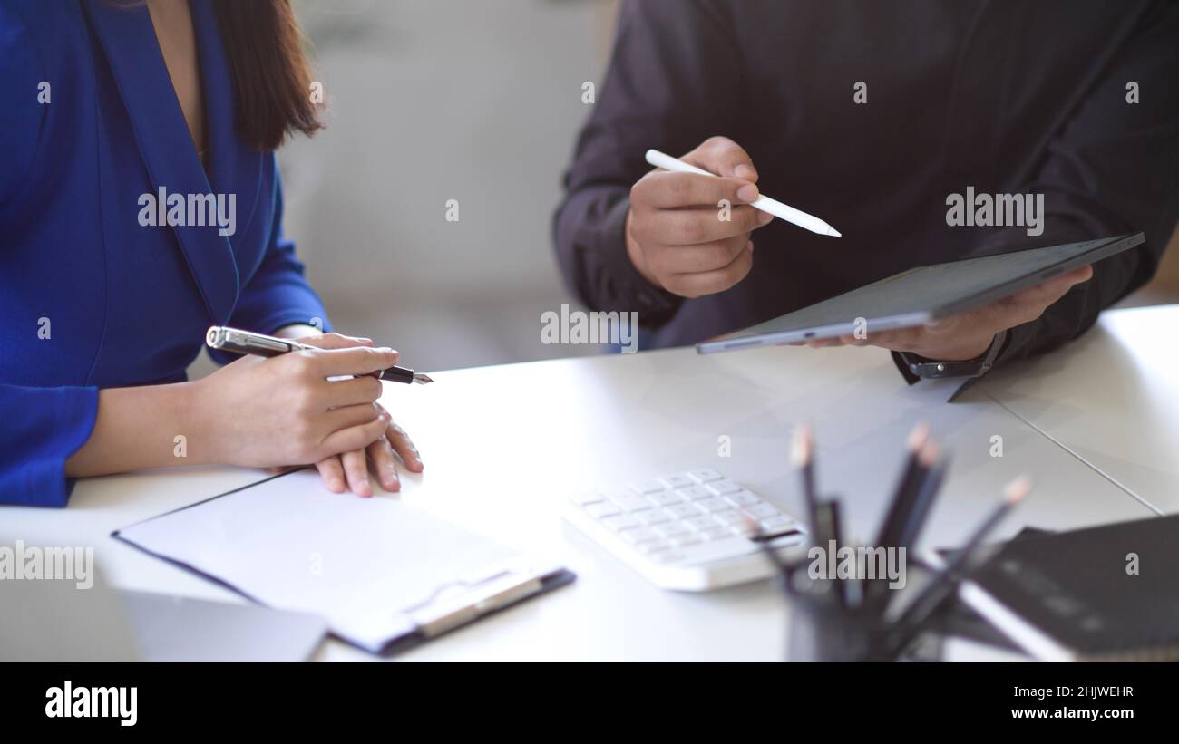 Close-up shot of a female marketing manager listening her male ...