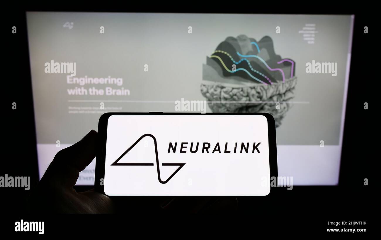 Person holding mobile phone with logo of US neurotechnology company ...