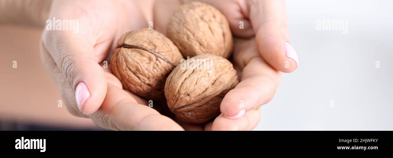 Walnuts in female hands hi-res stock photography and images - Alamy