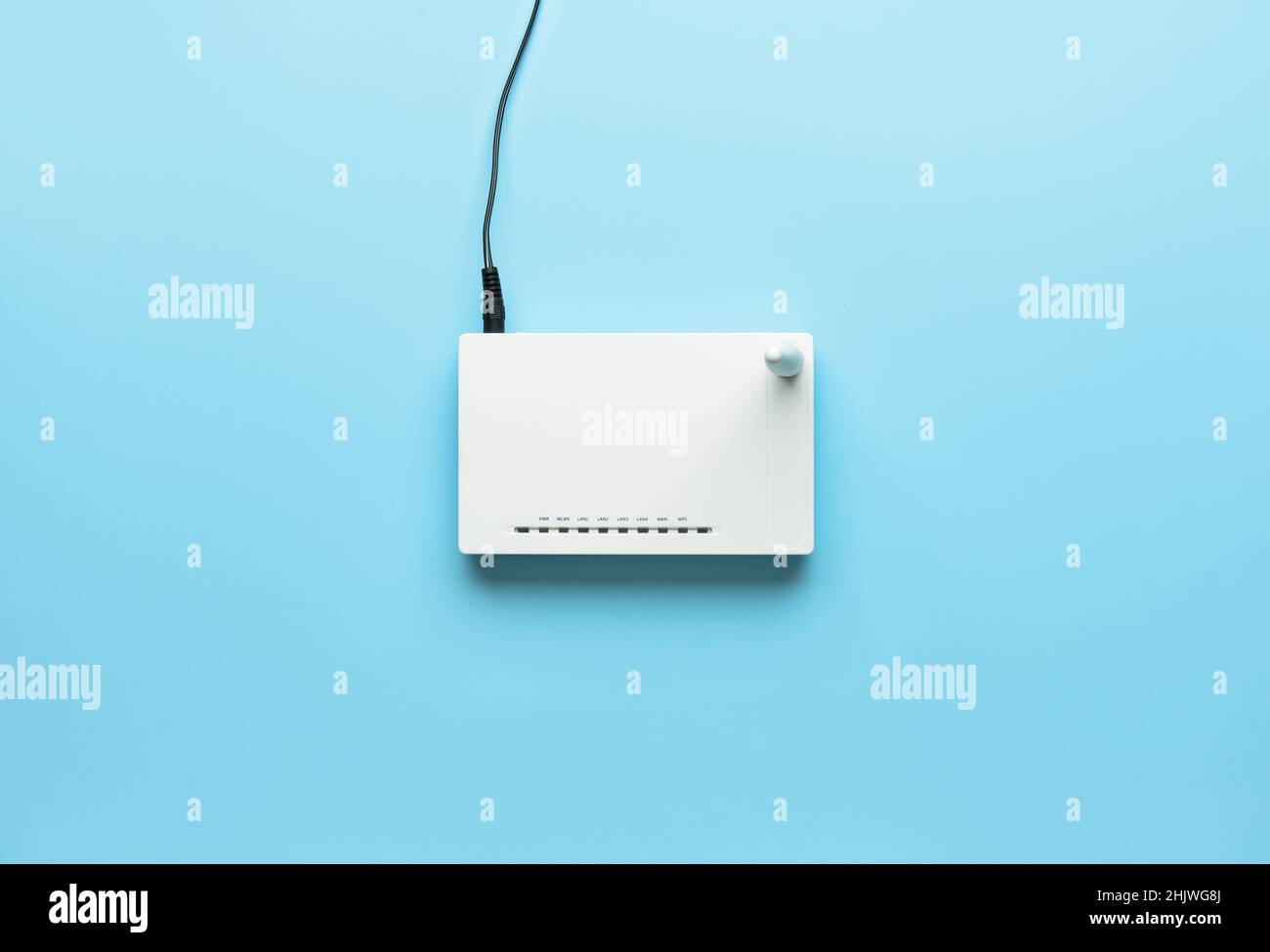 Wi-Fi router with antenna and network cable on color background Stock ...