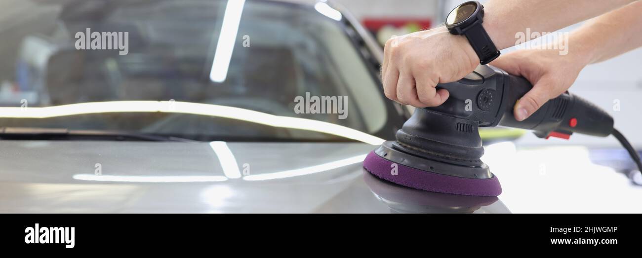Master polishes car body with polishing machine Stock Photo - Alamy