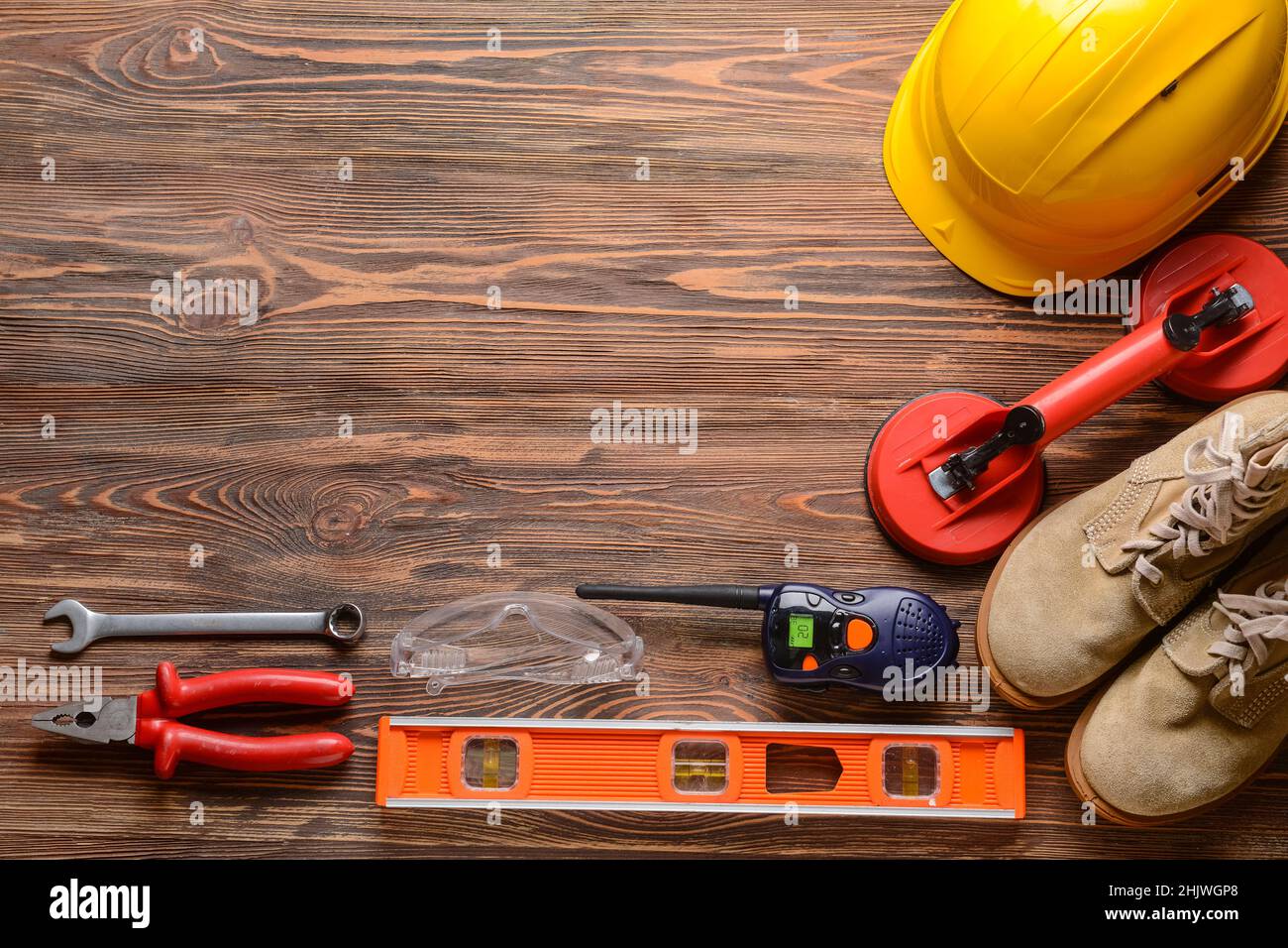 Safety equipment with builder's tools on wooden background Stock Photo ...