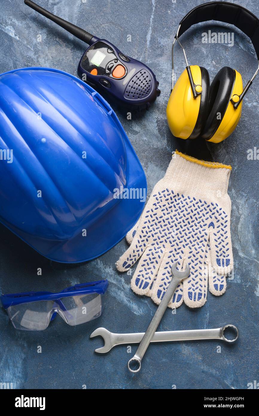 Safety equipment with builder's tools and radio transmitter on color ...