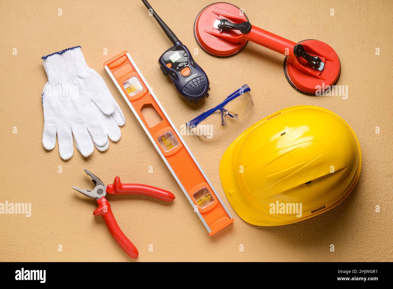 Safety equipment with builder's tools and radio transmitter on color ...