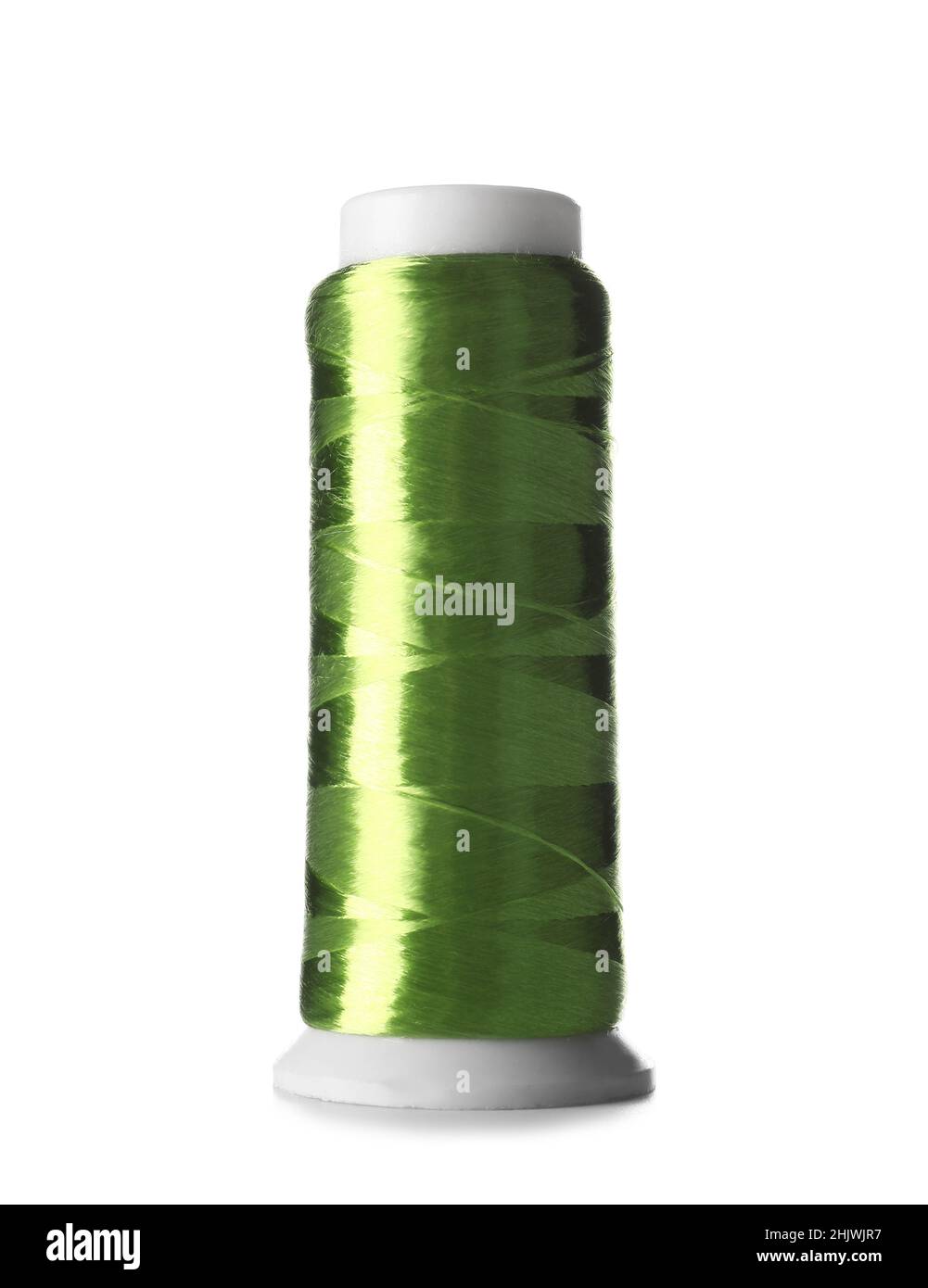 Green sewing thread spool on white background Stock Photo - Alamy