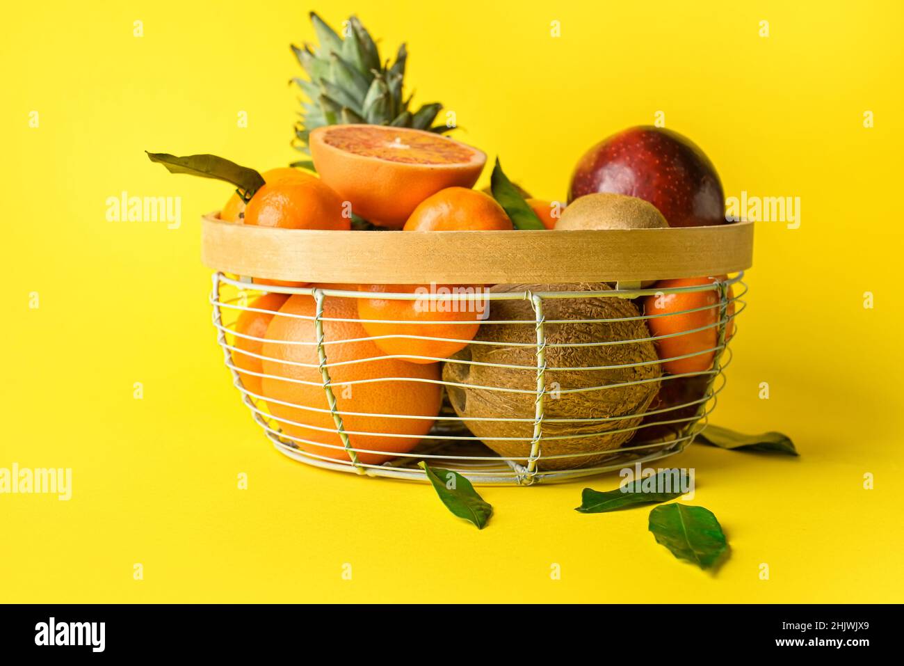 Basket with fresh juicy fruits on color background Stock Photo - Alamy