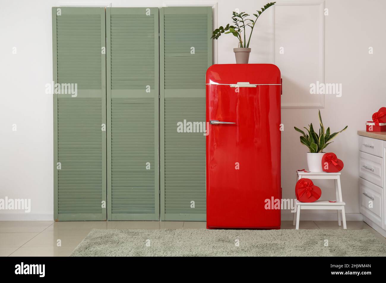 Stylish red fridge and stepladder stool with gift boxes for Valentine's ...
