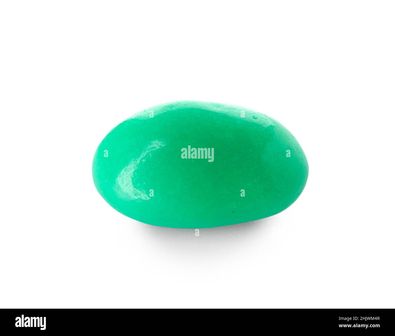Green jelly bean on white background Stock Photo - Alamy