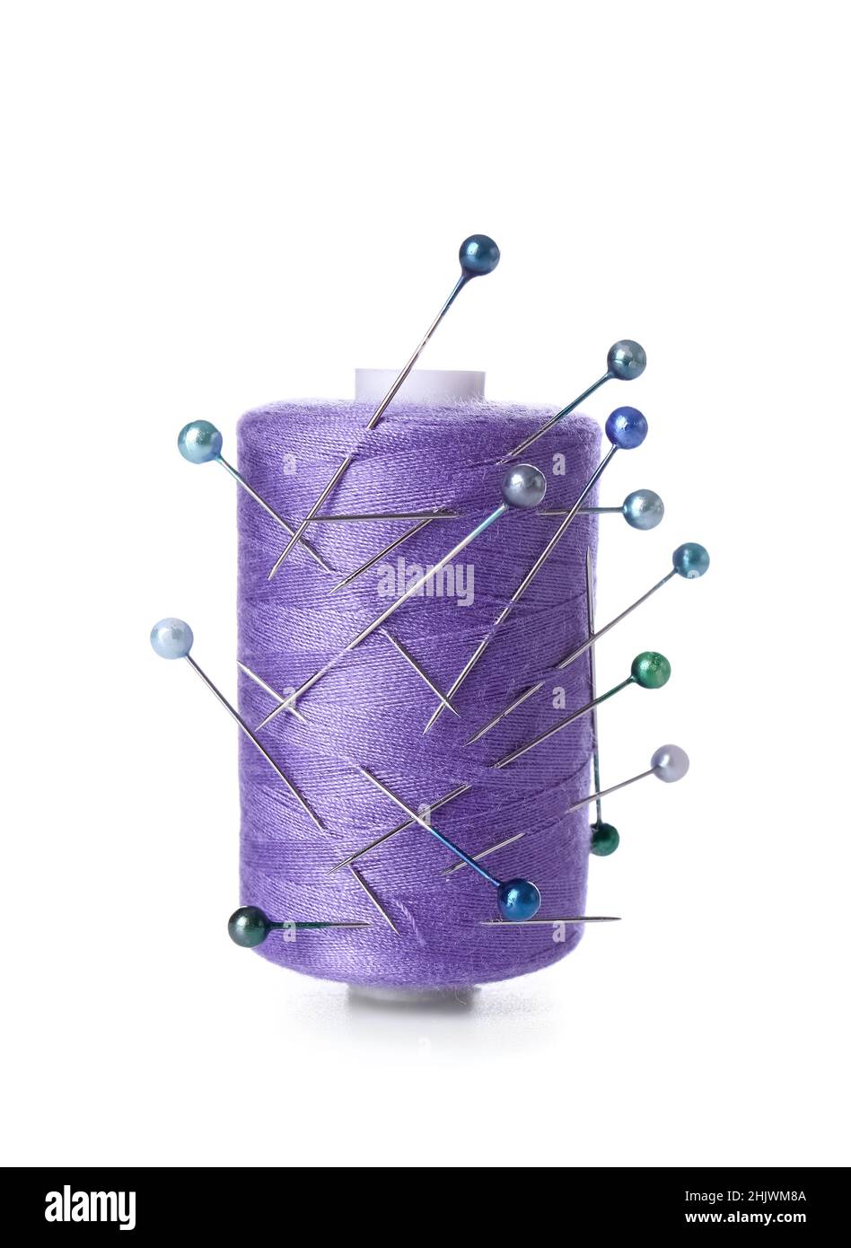 Purple thread spool with ball pins on white background Stock Photo - Alamy