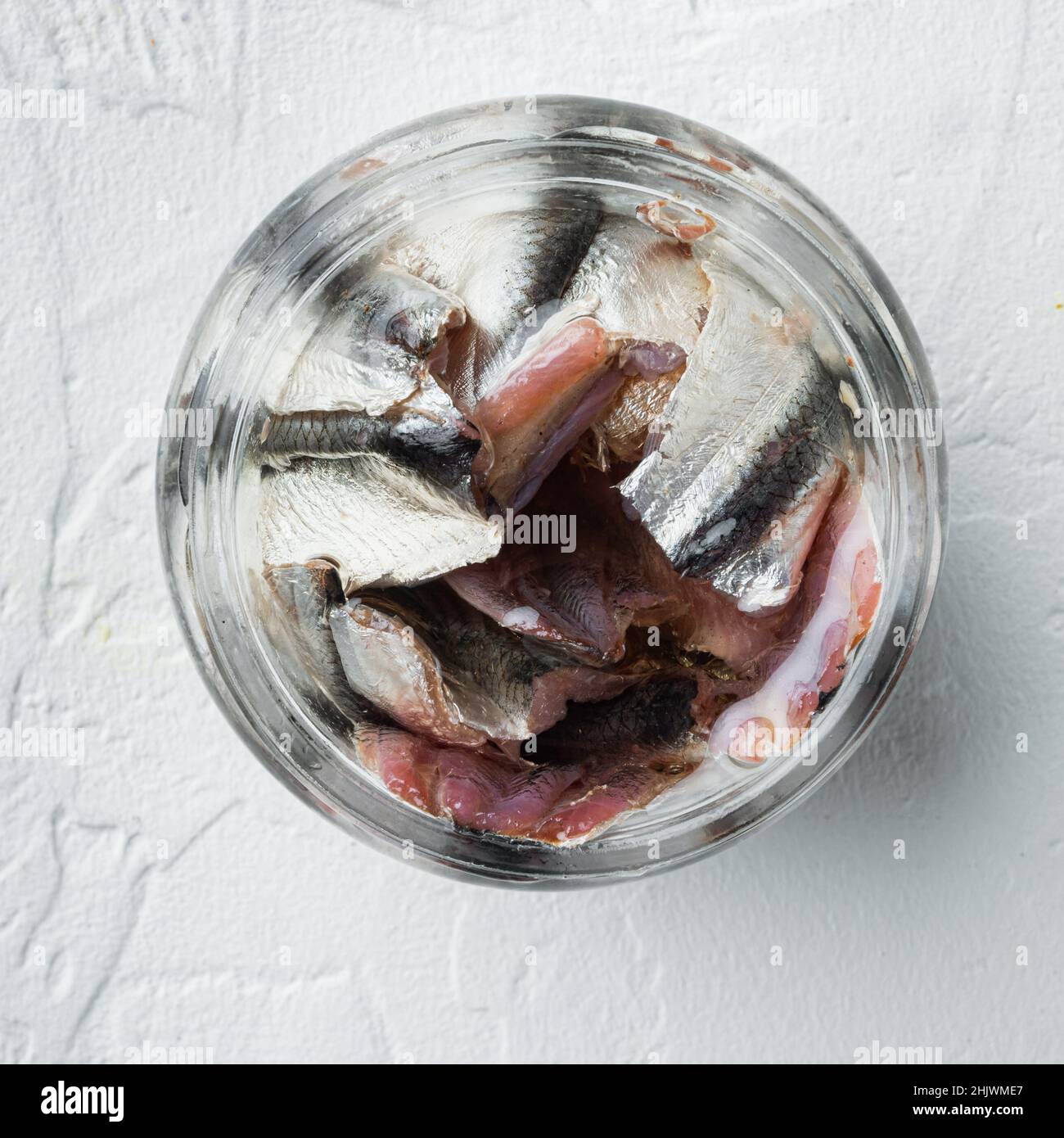 Anchovies canned fish in a tin can seafood set, in glass jar, on white ...