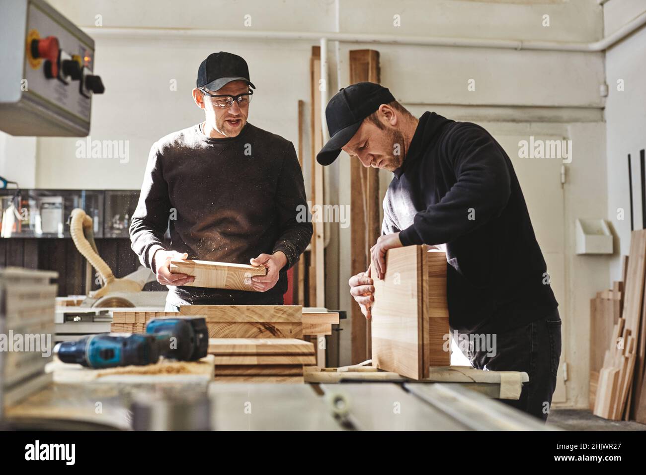 Portrait of woodworkers processing the surface of the woodwork at the ...