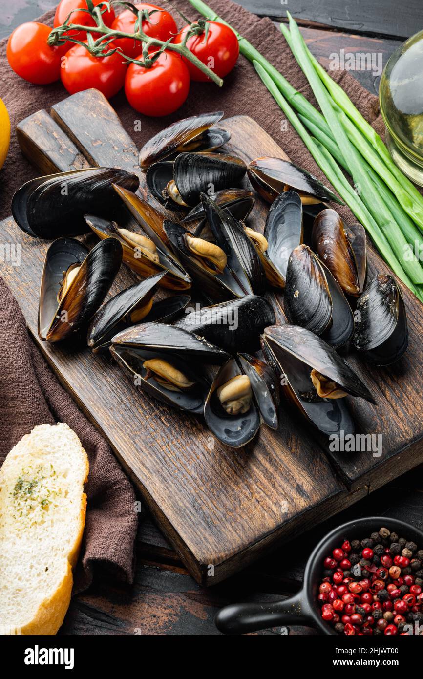 Boiled Mussels in shells with spices and herb, on wooden cutting board ...
